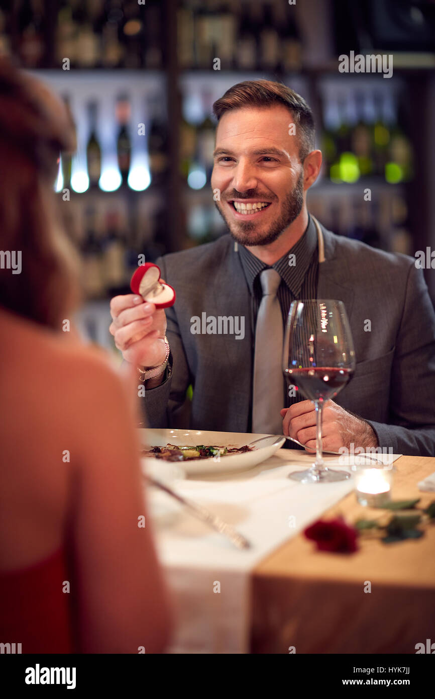 Happy man engaged woman in restaurant Stock Photo - Alamy