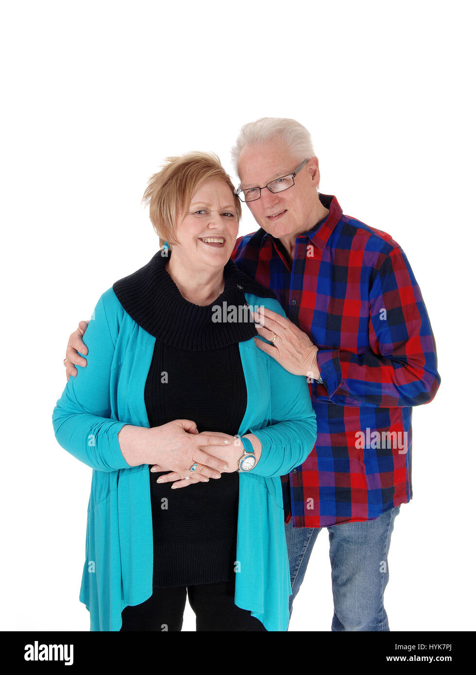 A lovely older couple standing in casual cloth, hugging each other ...