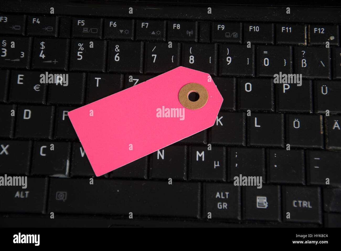 a paper tag on a keyboard Stock Photo - Alamy