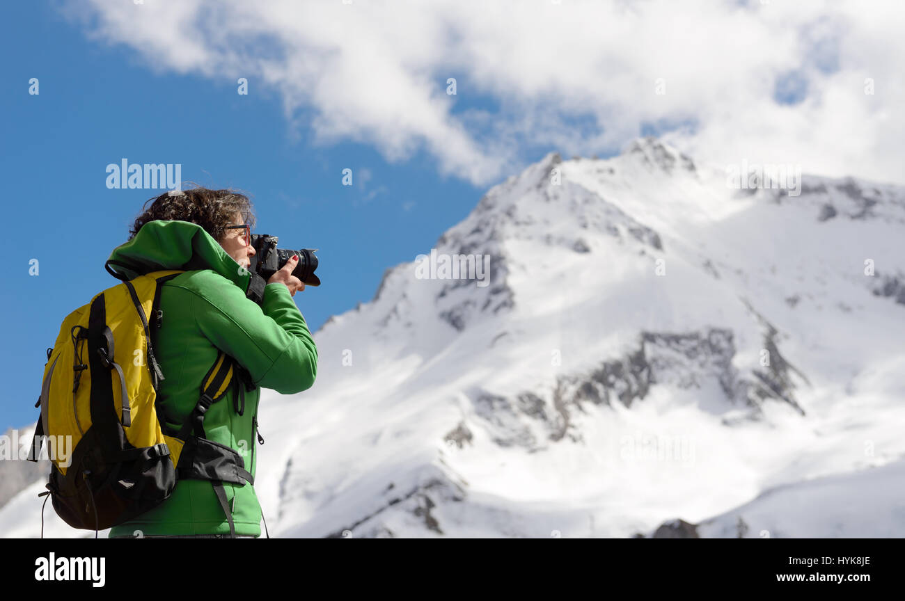 woman hiker with camera and backpack taking picture of beautiful ...