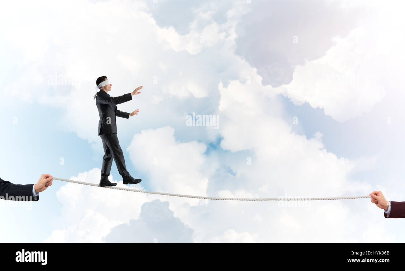 Business concept of risk support and assistance with man balancing on ...