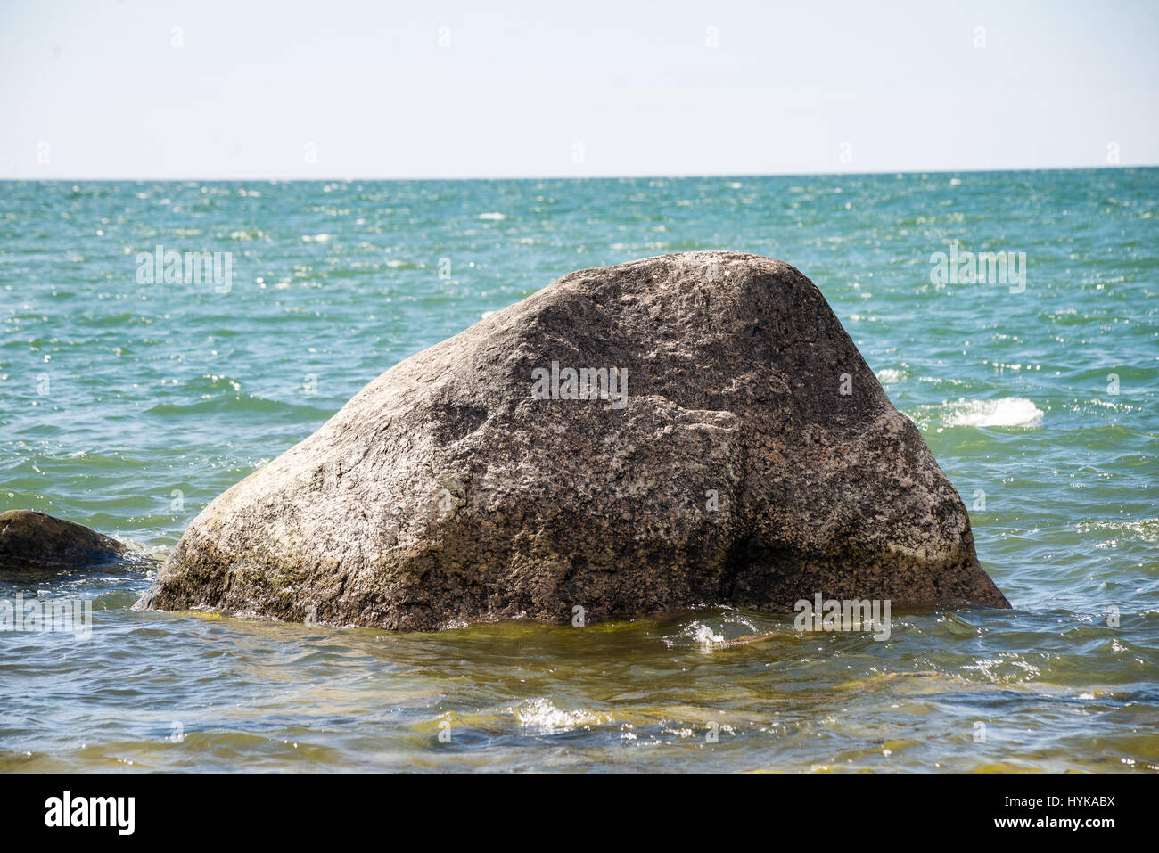 comfortable beach of the baltic sea with rocks and green vegetation in ...