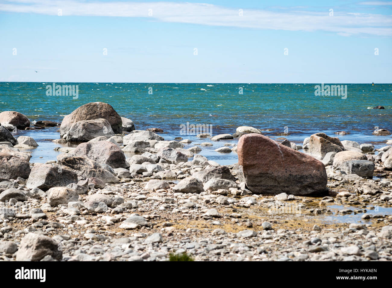 comfortable beach of the baltic sea with rocks and green vegetation in ...