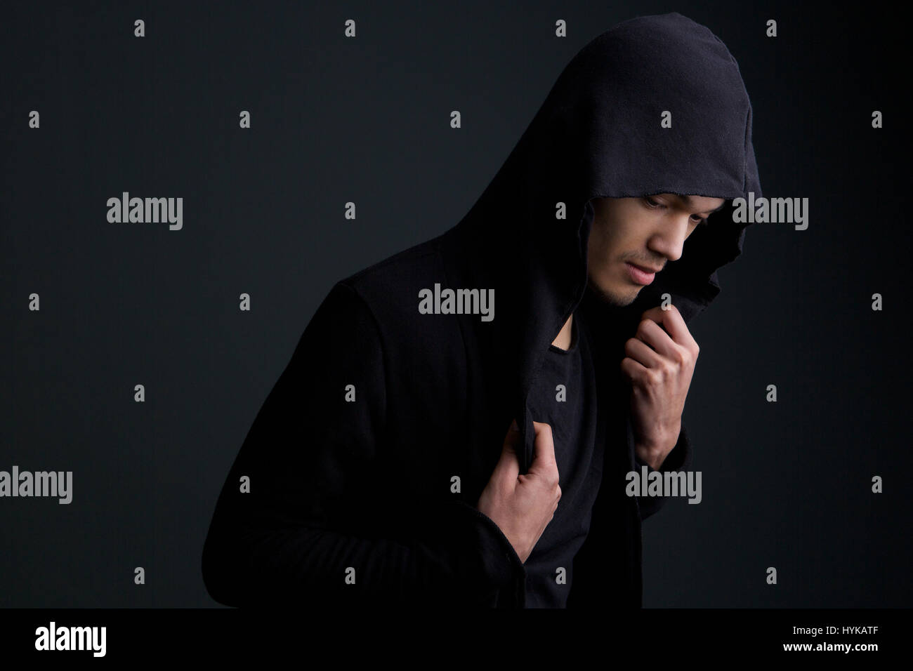 Horizontal portrait of a male fashion model posing on gray background ...