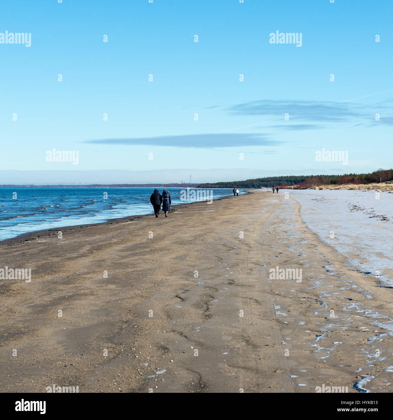 frozen sea beach with blue sky and snow covered tracks Stock Photo - Alamy