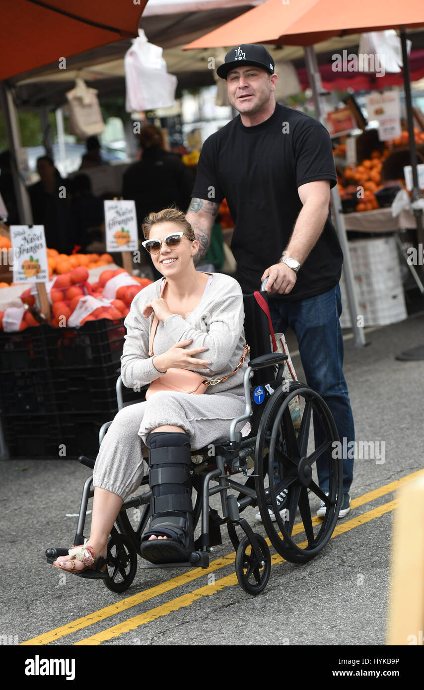 Jodie Sweetin, with a broken leg, is pushed in her wheelchair by her ...