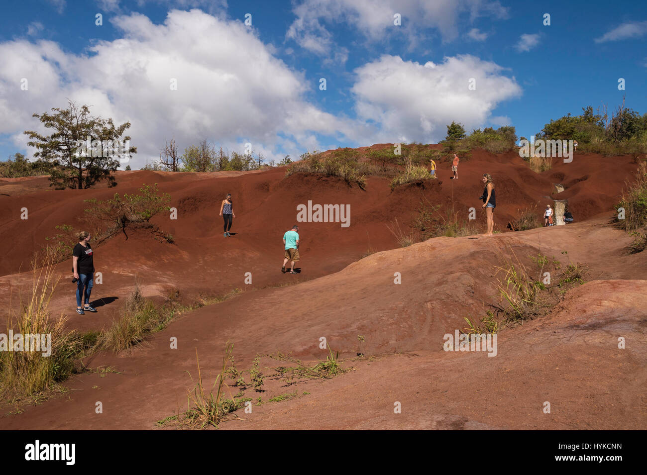 Tourists walking on red rocks, Waimea Canyon Drive, Koke'e State Park ...