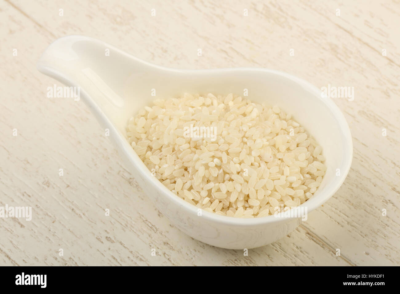 Raw rice heap in the bowl - ready for cooking Stock Photo - Alamy