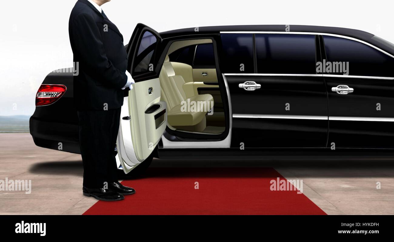 Driver waiting and standing next to the black limousine on a red carpet ...