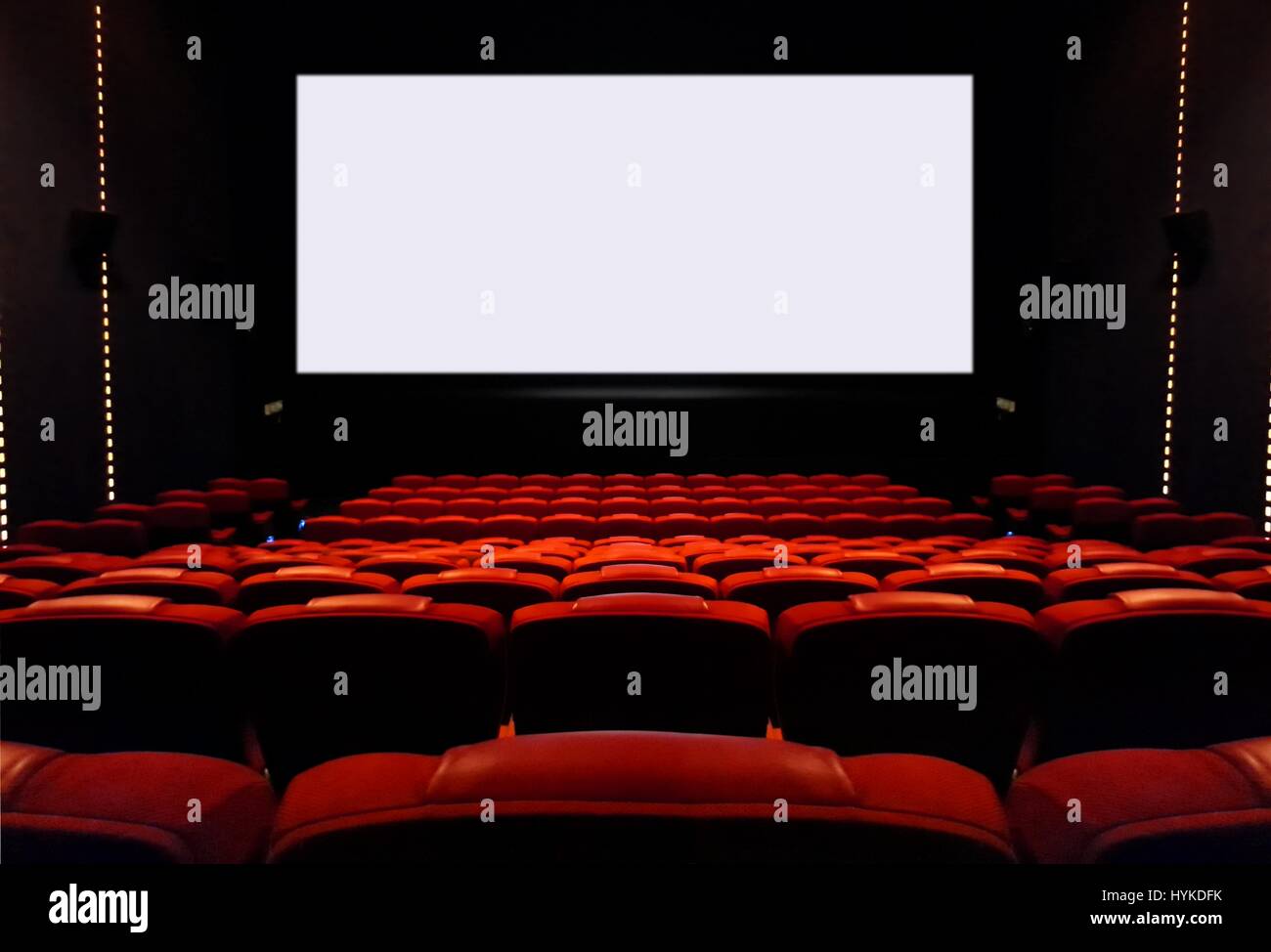 Empty cinema seats with blank white screen Stock Photo - Alamy