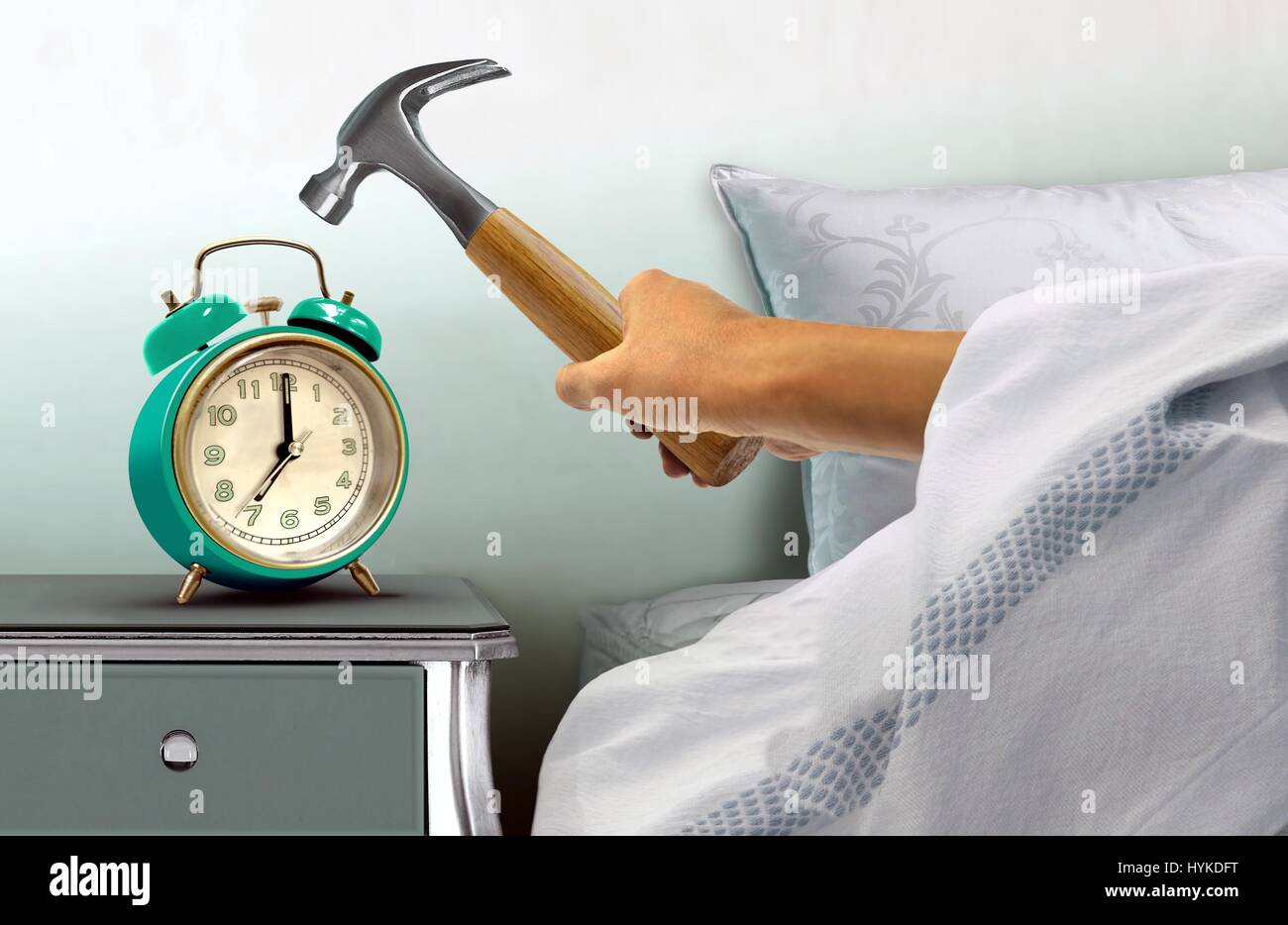Man smashing alarm clock with hammer Stock Photo - Alamy