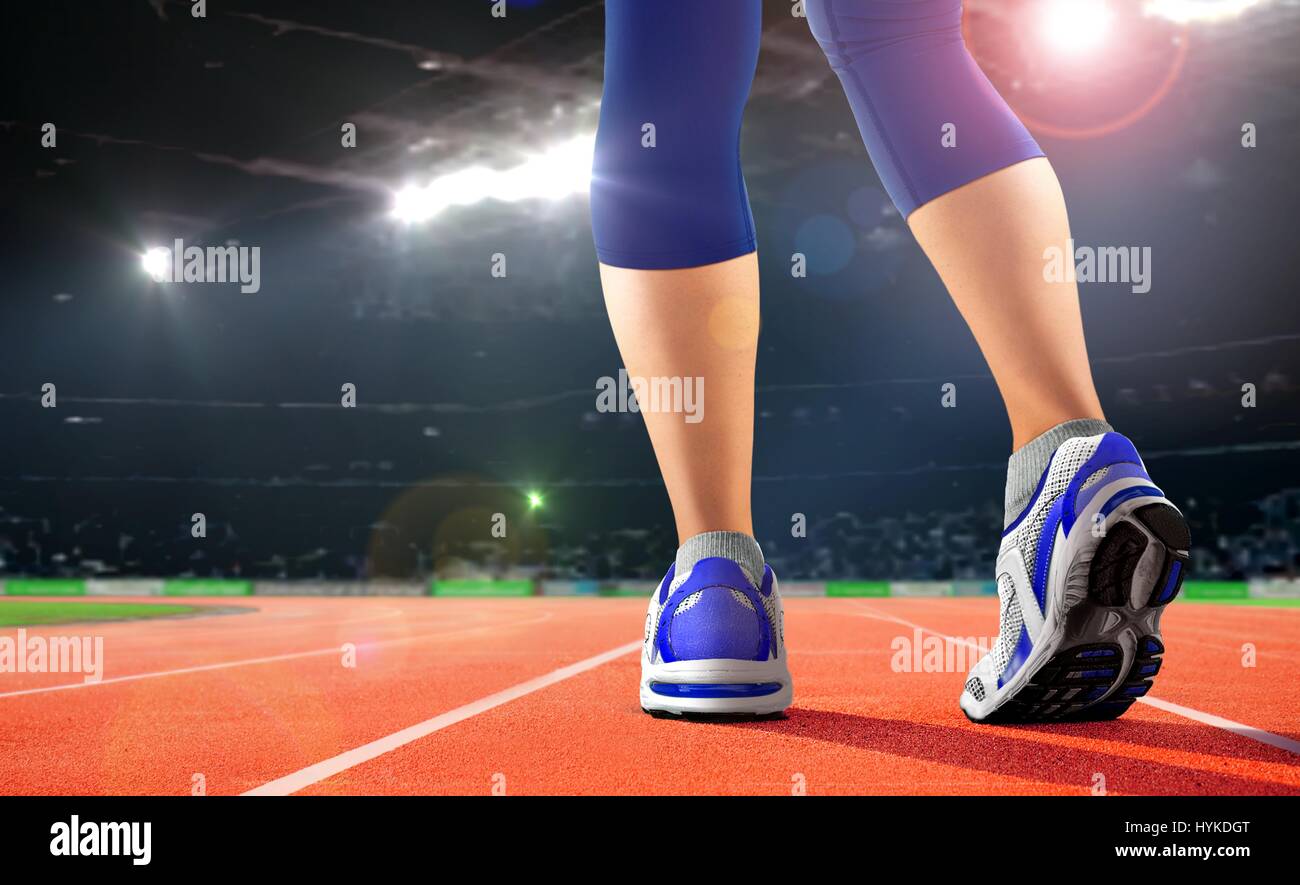 Legs of athlete on running track in the stadium Stock Photo - Alamy