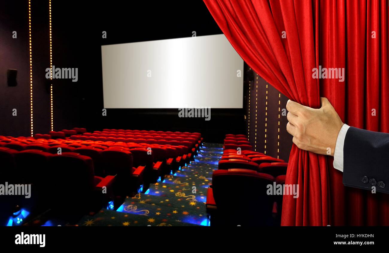Cinema seats and blank screen with hand opening red curtain Stock Photo ...
