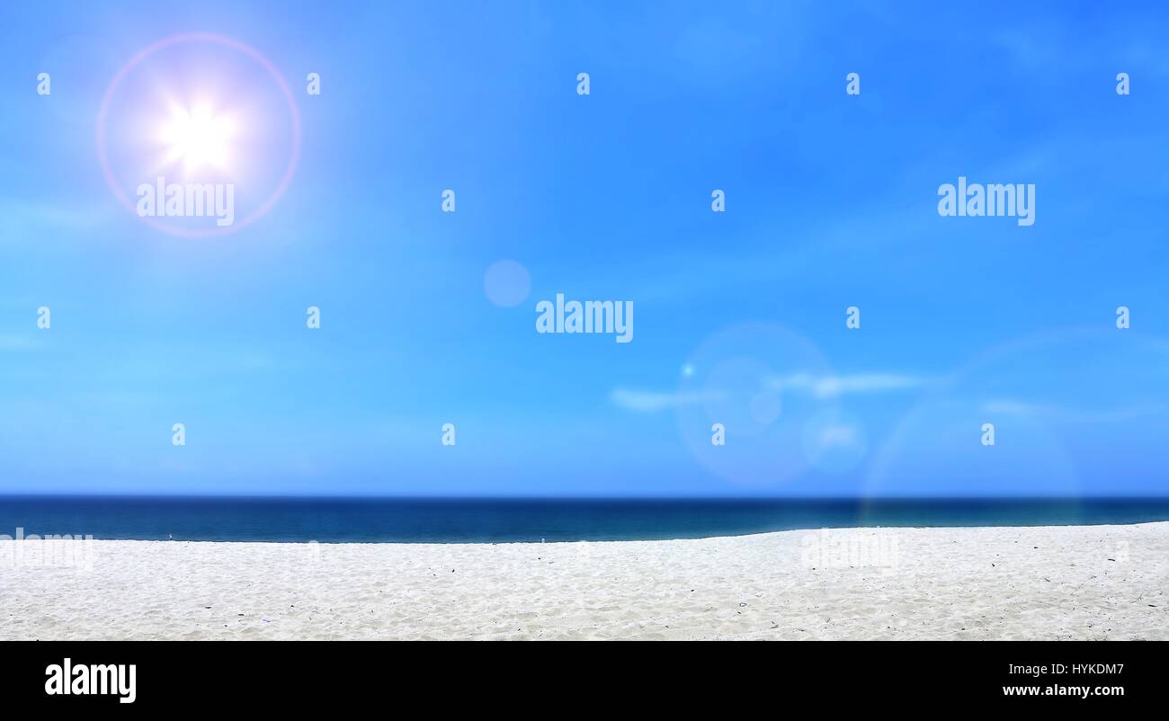 Sandy beach under blue sky background Stock Photo - Alamy