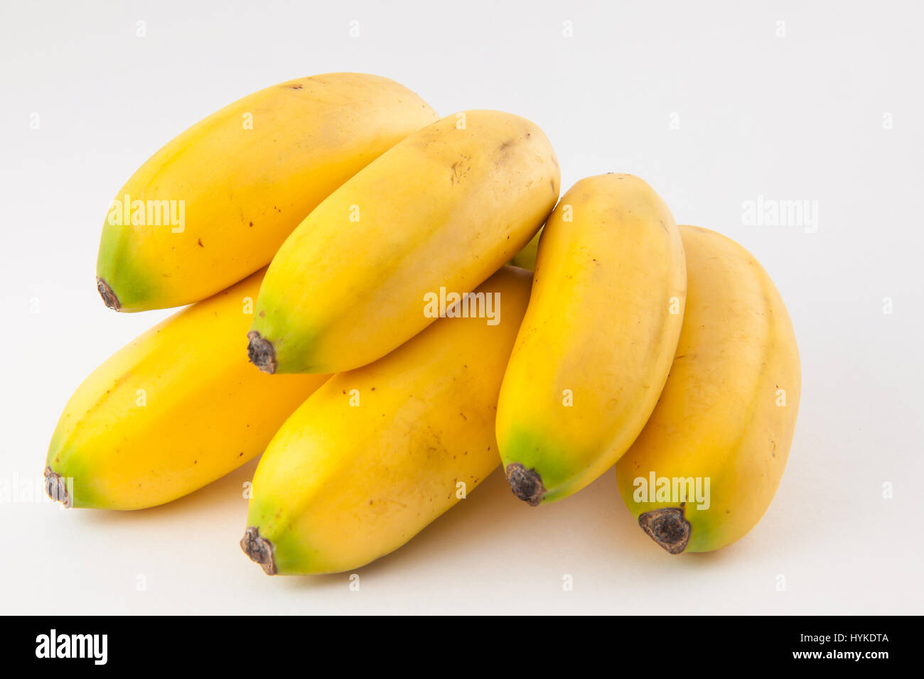 Small type of banana called murrapo (Musa acuminata) on white ...