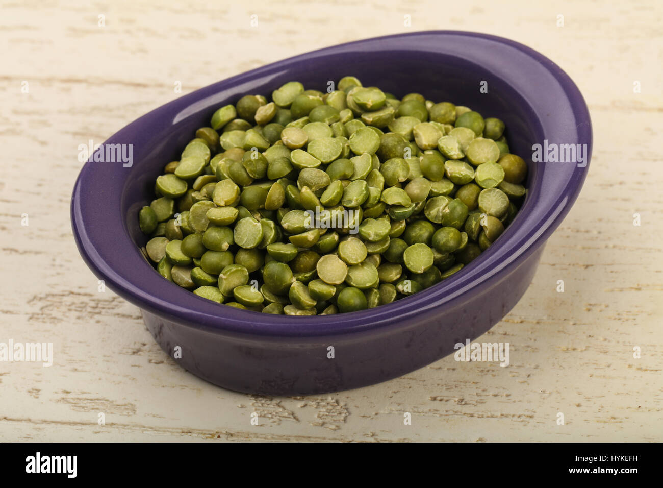 Green peas pile in the bowl over wooden background Stock Photo - Alamy