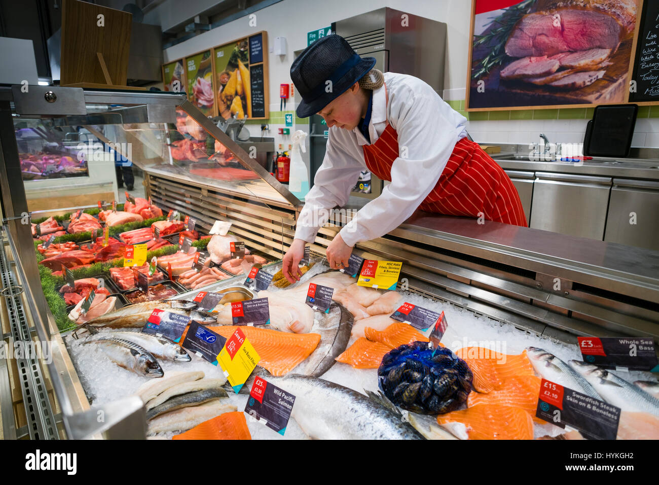 A young woman girl 'colleague' working on the fresh fish section of the ...