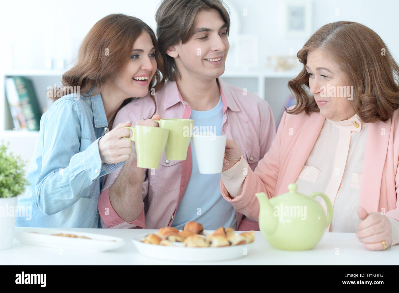 Happy family drinking tea together Stock Photo - Alamy