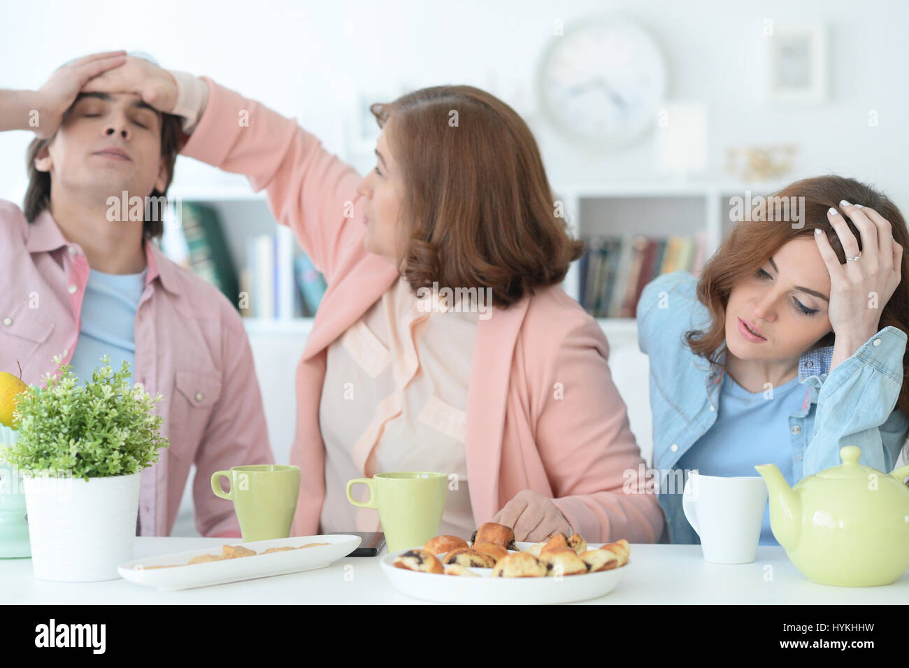 Happy family drinking tea together Stock Photo - Alamy