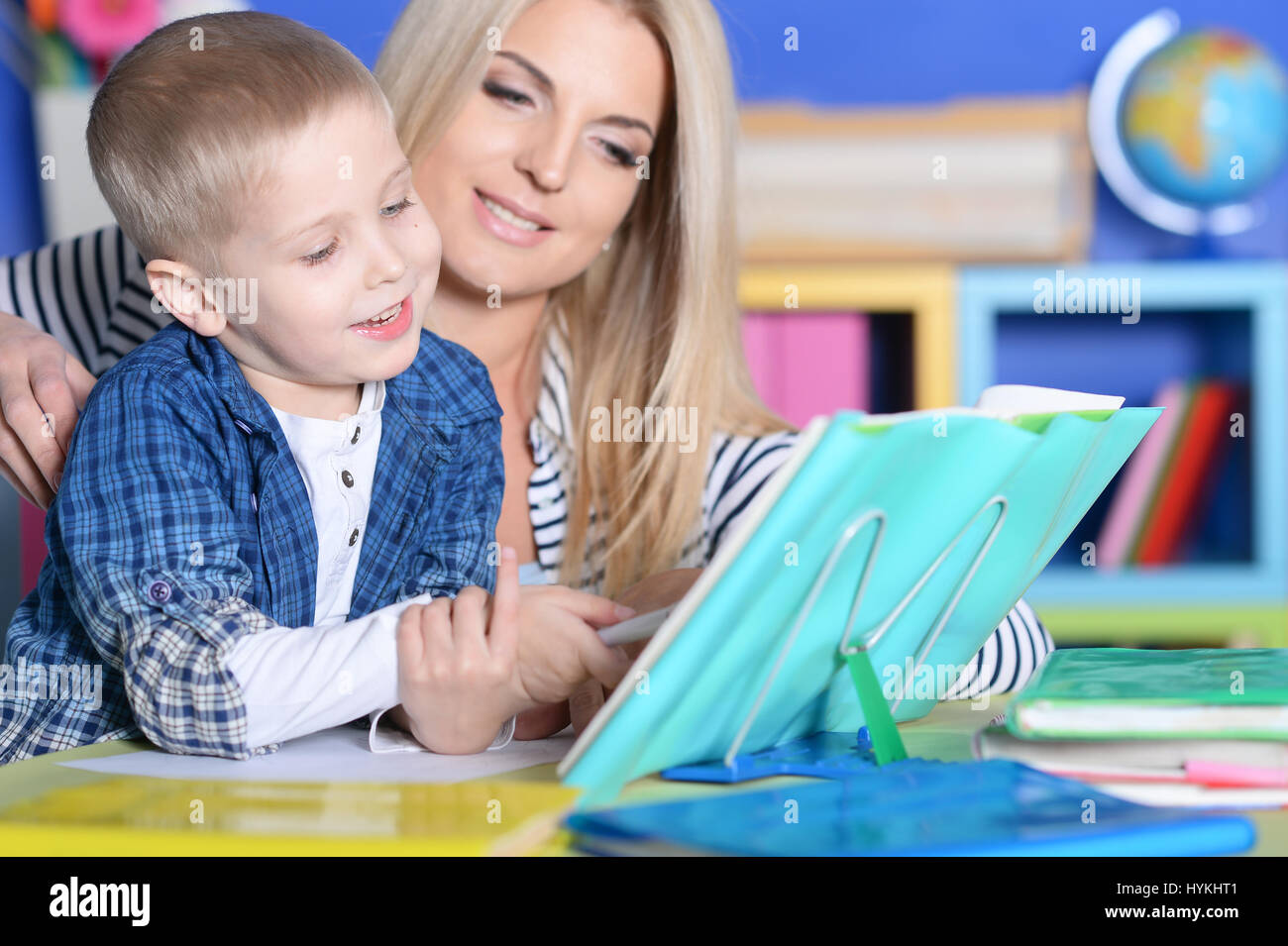 Mother helping her son with lessons Stock Photo - Alamy