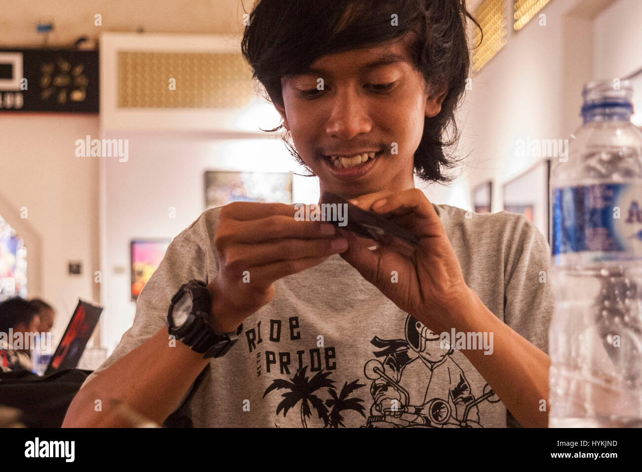 An Indonesian man make filters for take a picture solar eclipse at cafe ...