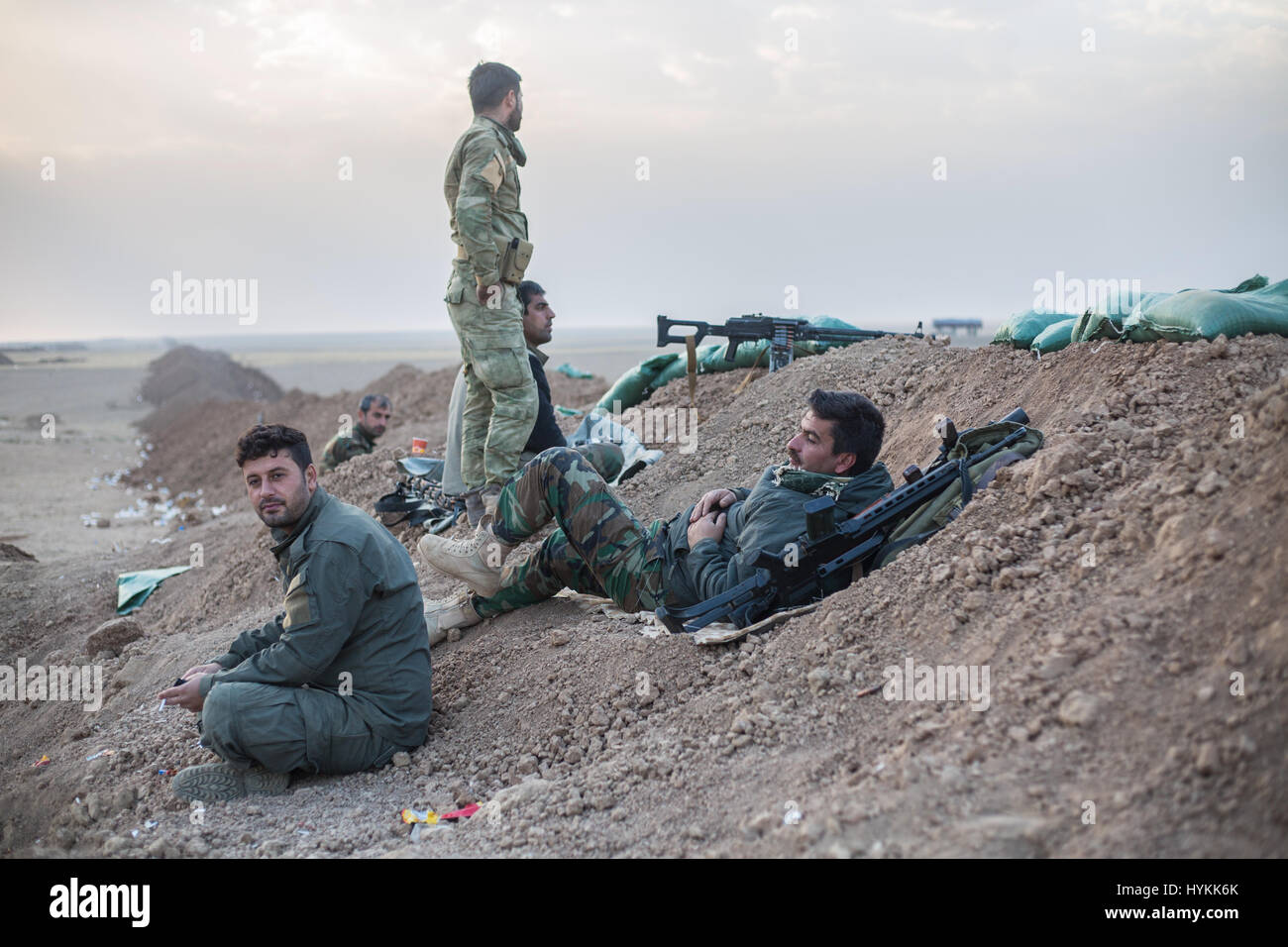 MOSUL, IRAQ: Kurdish soldiers on a trench facing towards the general ...