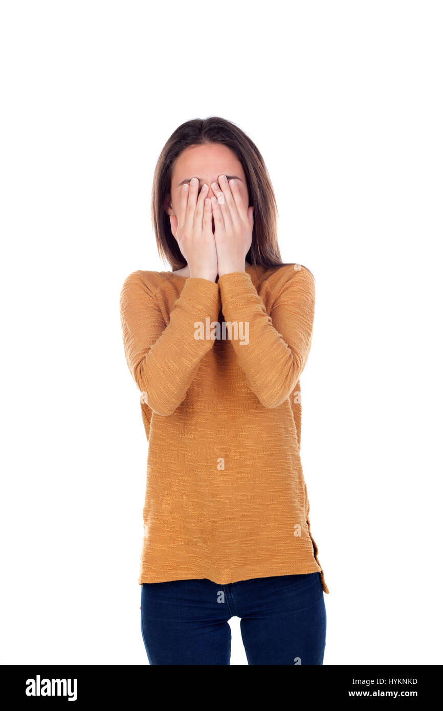 Sad teenager girl covering her face with the hands isolated on a white ...