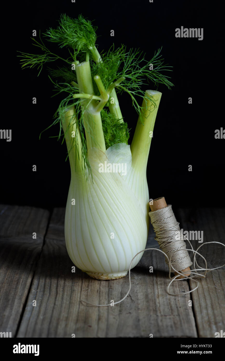 Fresh fennel bulb on wooden table. Close up fresh organic vegetables ...