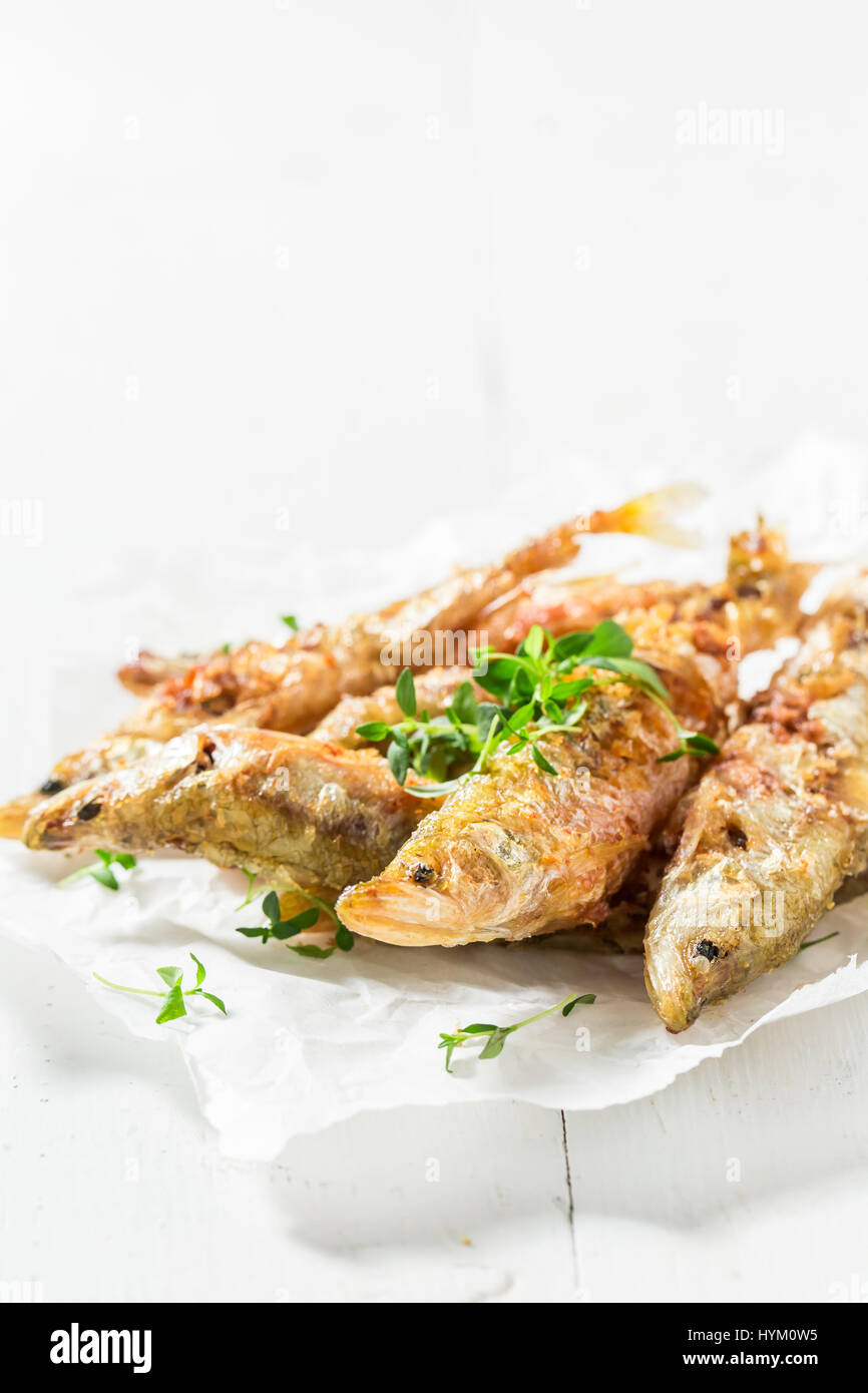 Tasty roasted smelt fish with salt and herbs Stock Photo - Alamy