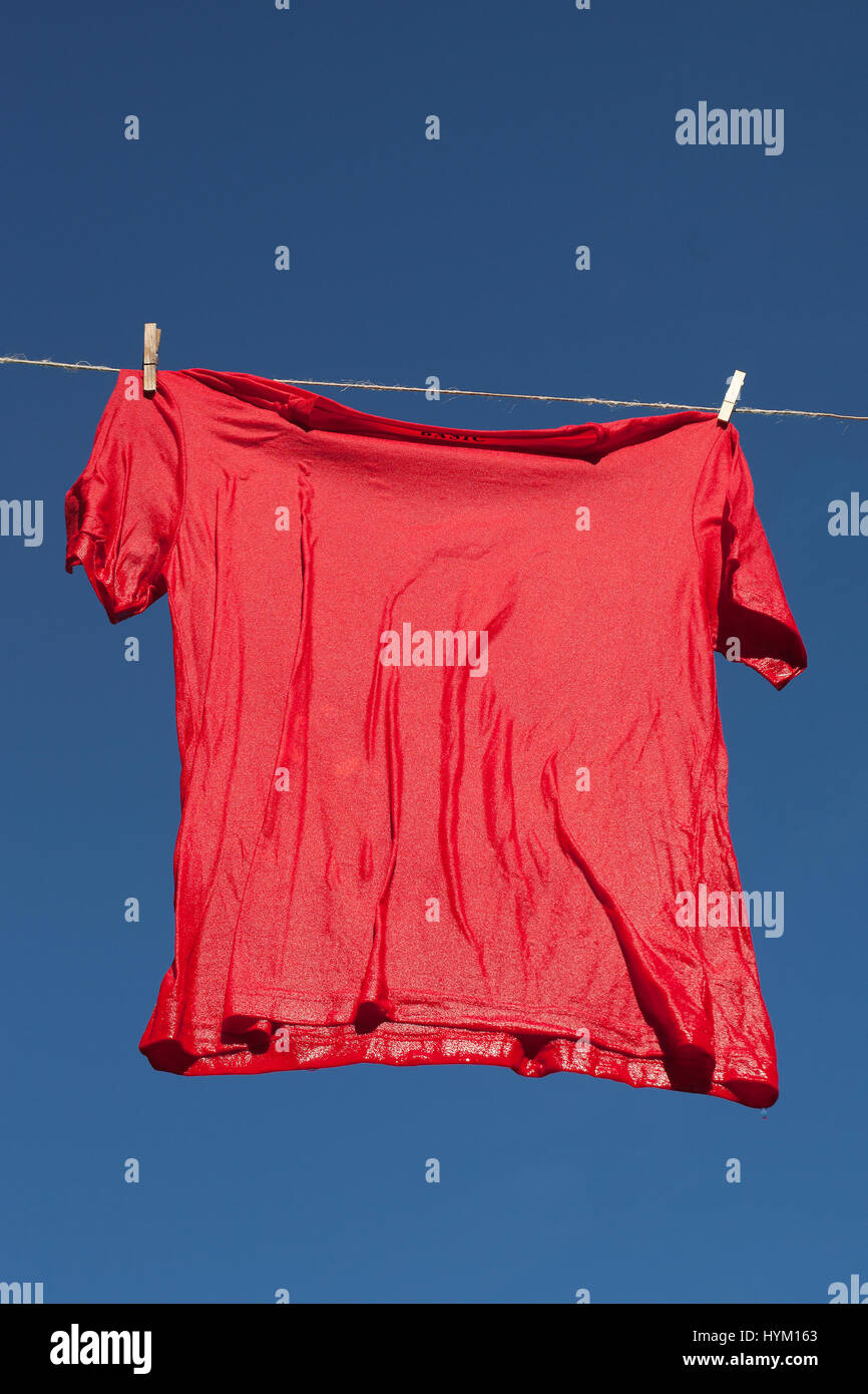Red t-shirt on clothesline Stock Photo - Alamy
