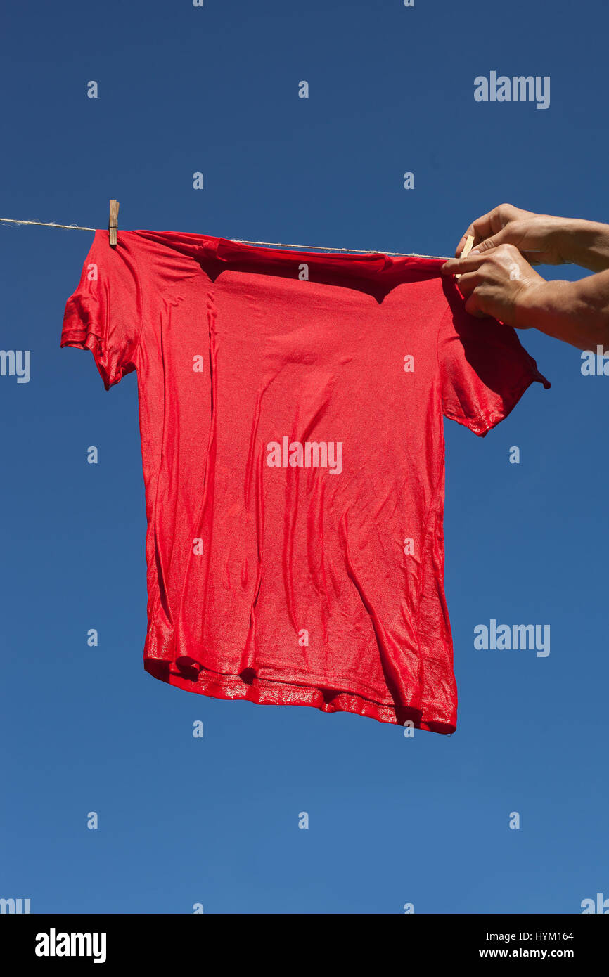 Red t-shirt on clothesline Stock Photo - Alamy
