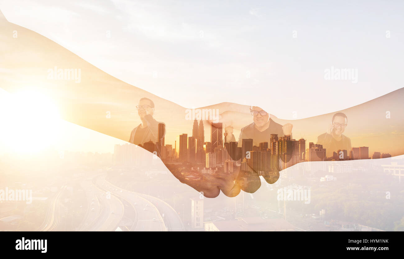 Double exposure of Partners shaking hands Stock Photo - Alamy