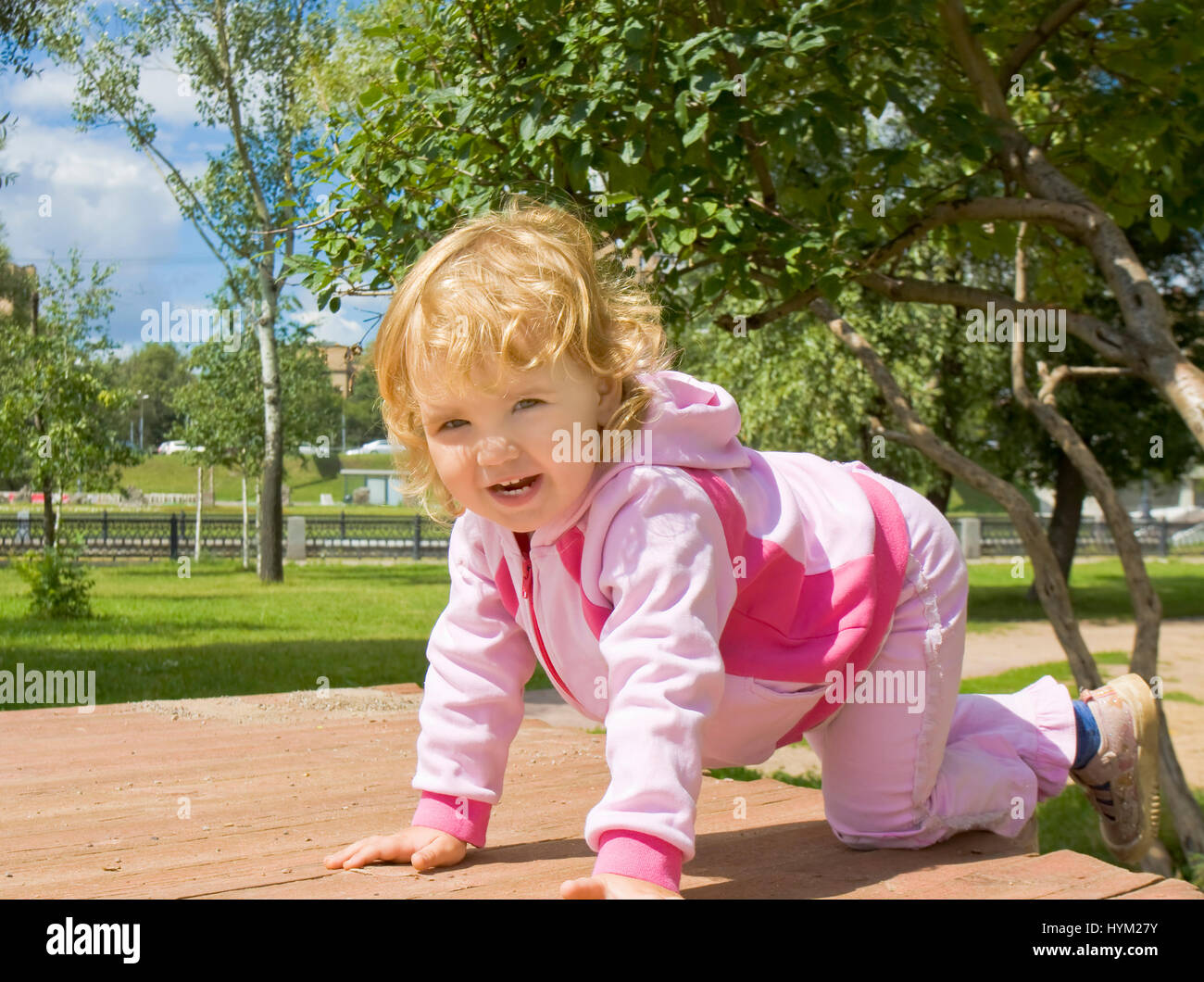 Little child girl Caucasian creeping on knees on walk outdoors Stock ...
