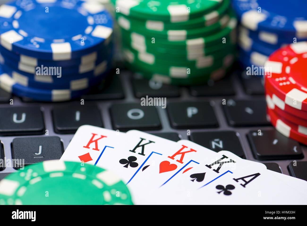 Casino chips and cards stacking on a laptop Stock Photo - Alamy