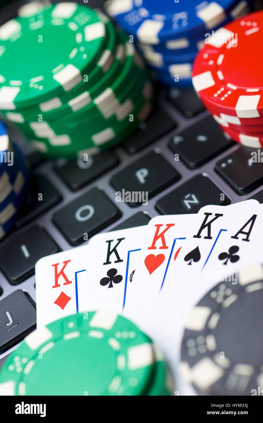 Casino chips and cards stacking on a laptop Stock Photo - Alamy