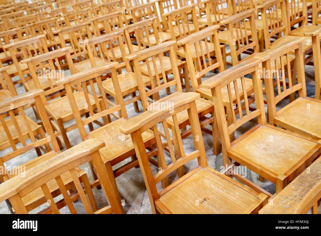 Huge group of wooden chairs arranged in rows Stock Photo - Alamy
