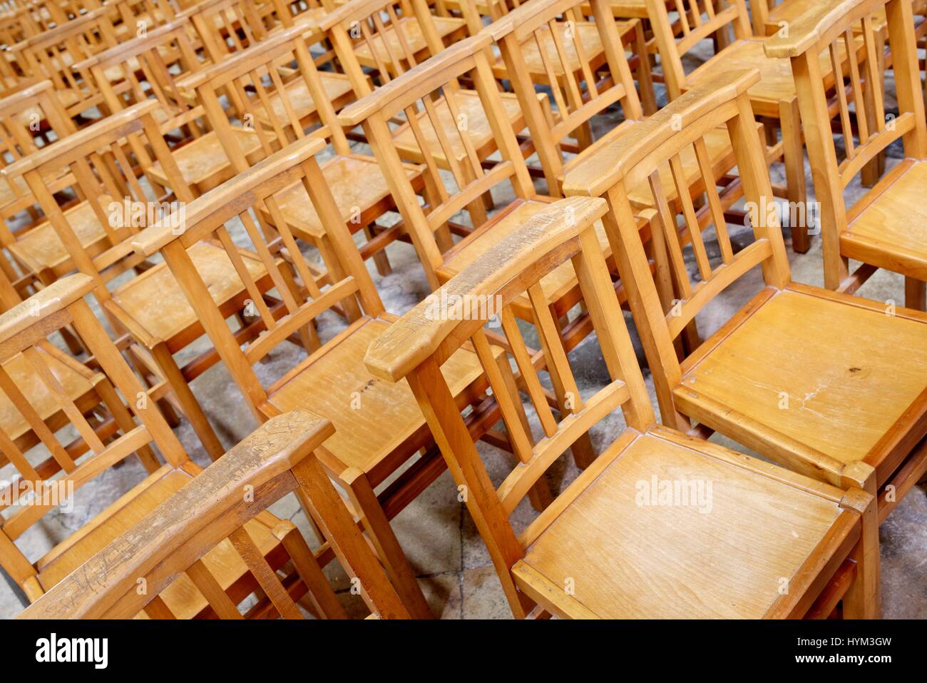 Huge group of wooden chairs arranged in rows Stock Photo - Alamy