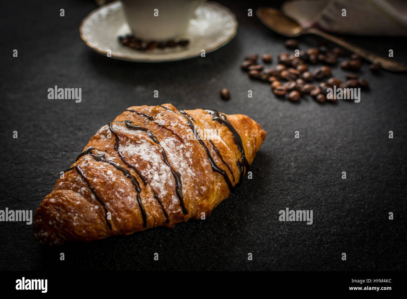 Traditional french breakfast croissant with chocolate and coffee on ...