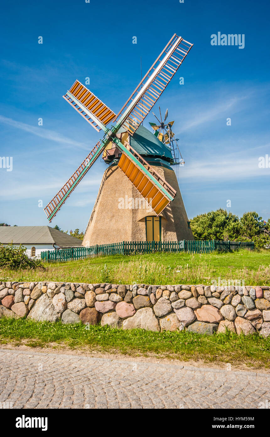 Traditional windmill in beautiful scenery with blue sky and clouds on a ...