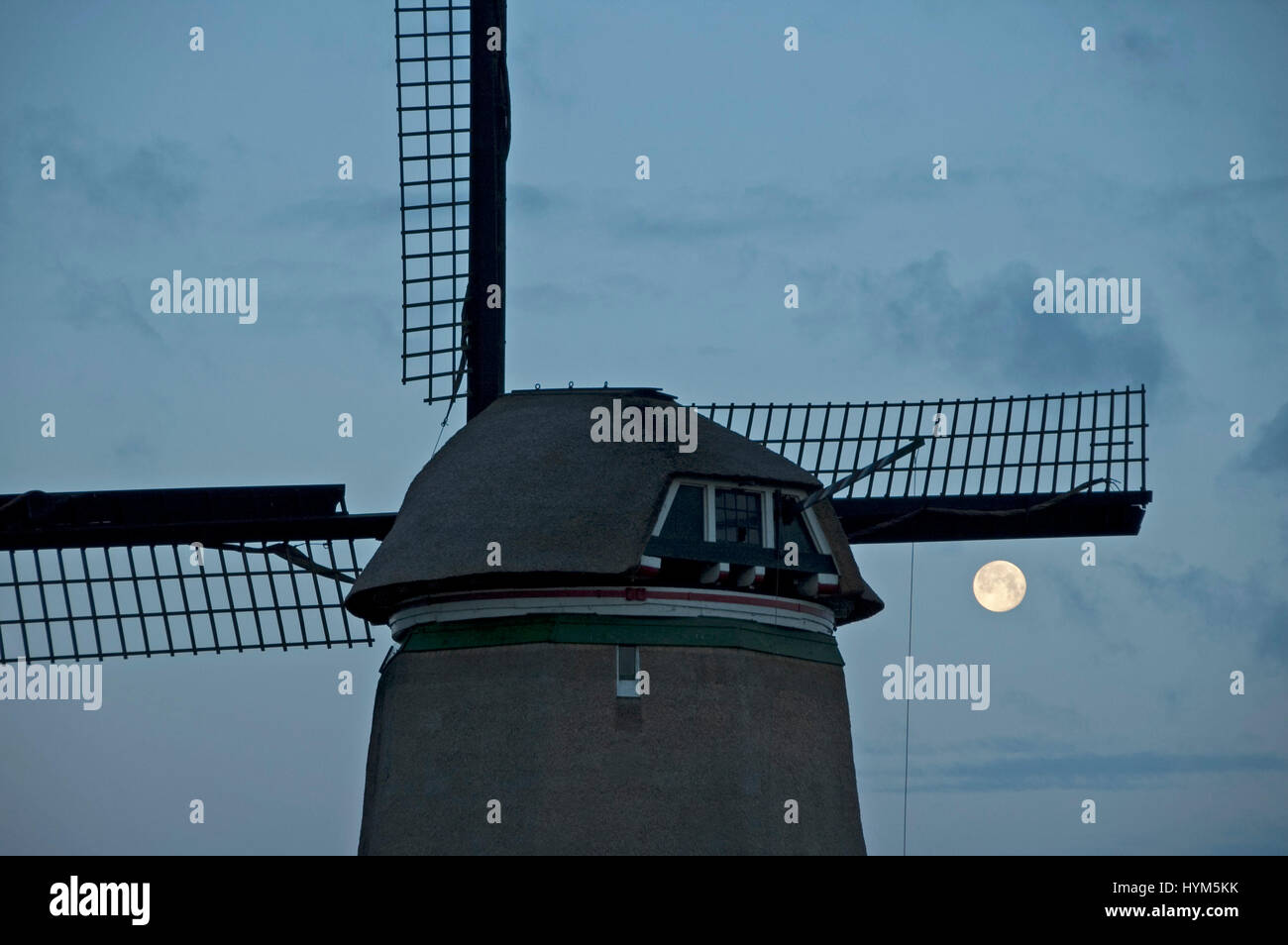 The moon shining on a windmill in the night Stock Photo - Alamy