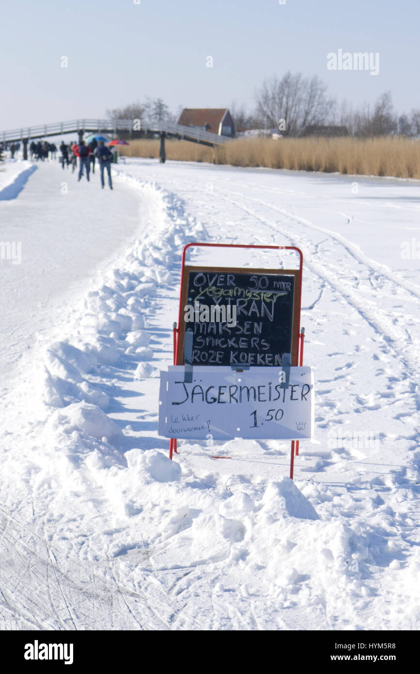 'Koek en Sopie' blackboard in the snow. A snack and a drink during ...