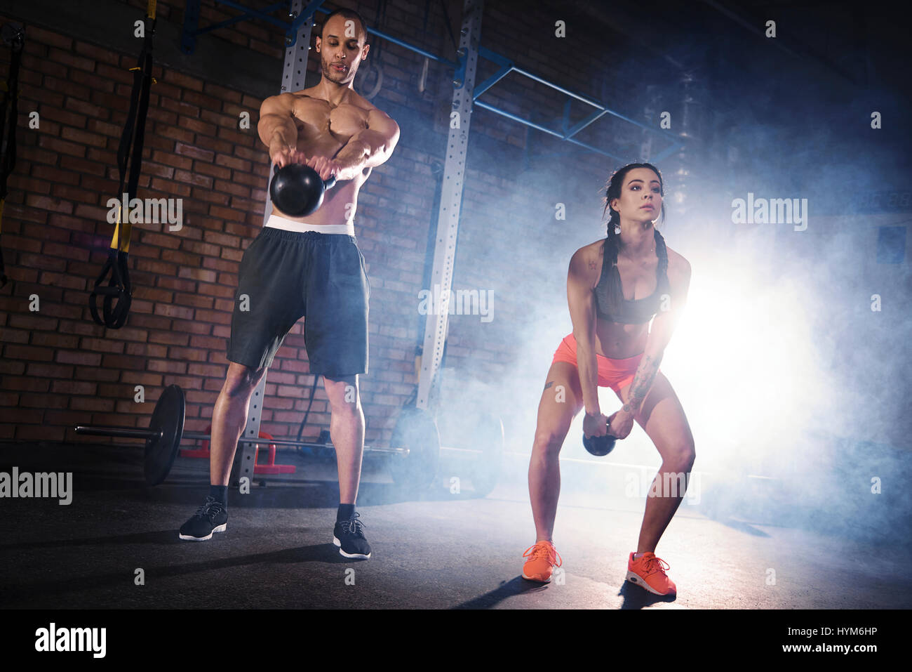 Fit couple practicing with kettlebell Stock Photo - Alamy