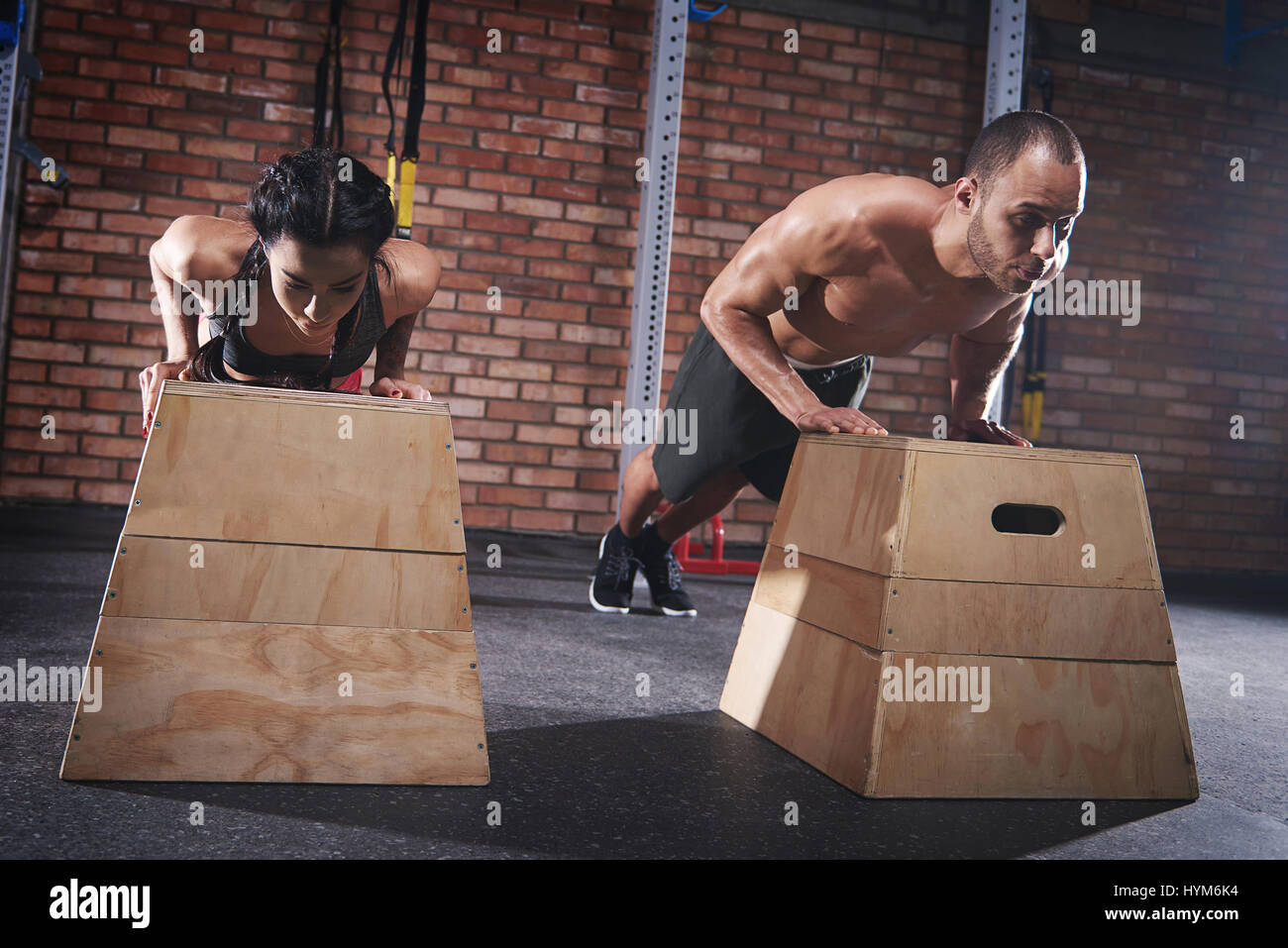Focus couple doing push ups on platforms Stock Photo - Alamy