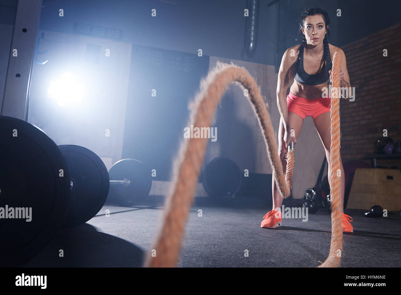 Young woman tossing ropes at gymnasium Stock Photo - Alamy