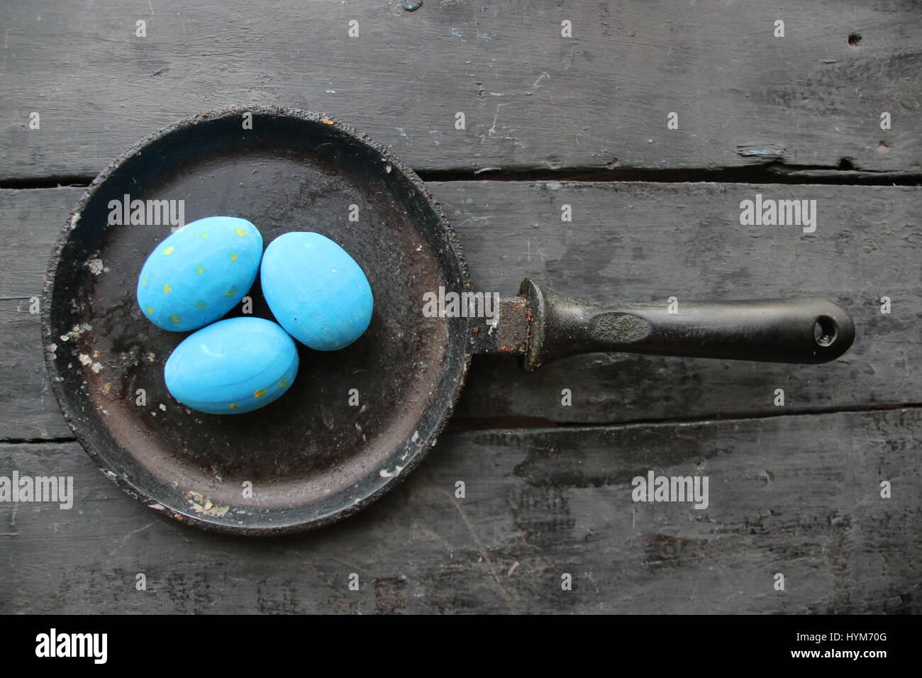 Blue Easter eggs in a frying pan, art holiday decoration Stock Photo ...
