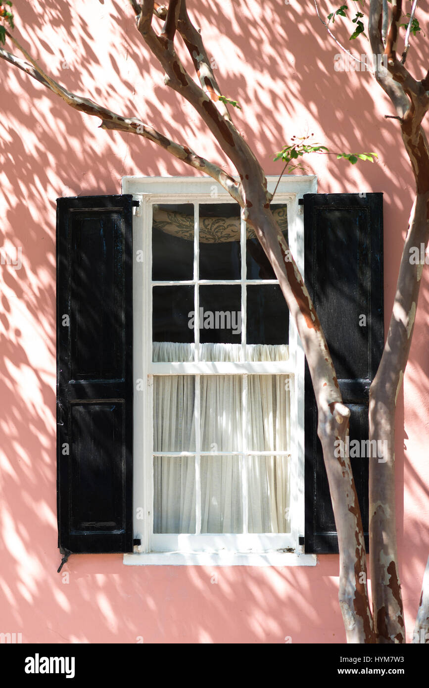Pink house with black shutter window Stock Photo - Alamy