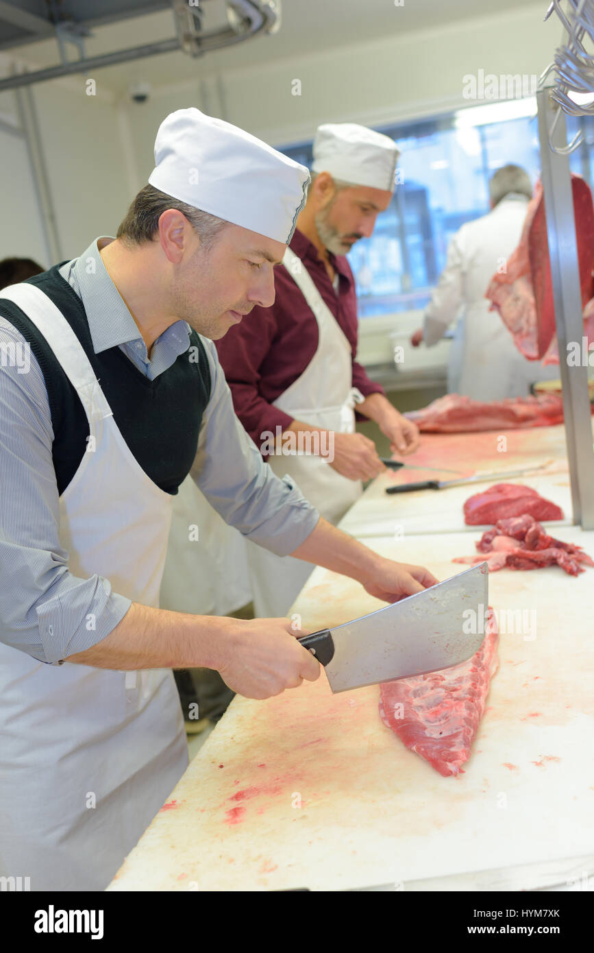Butchers cutting up meat Stock Photo - Alamy