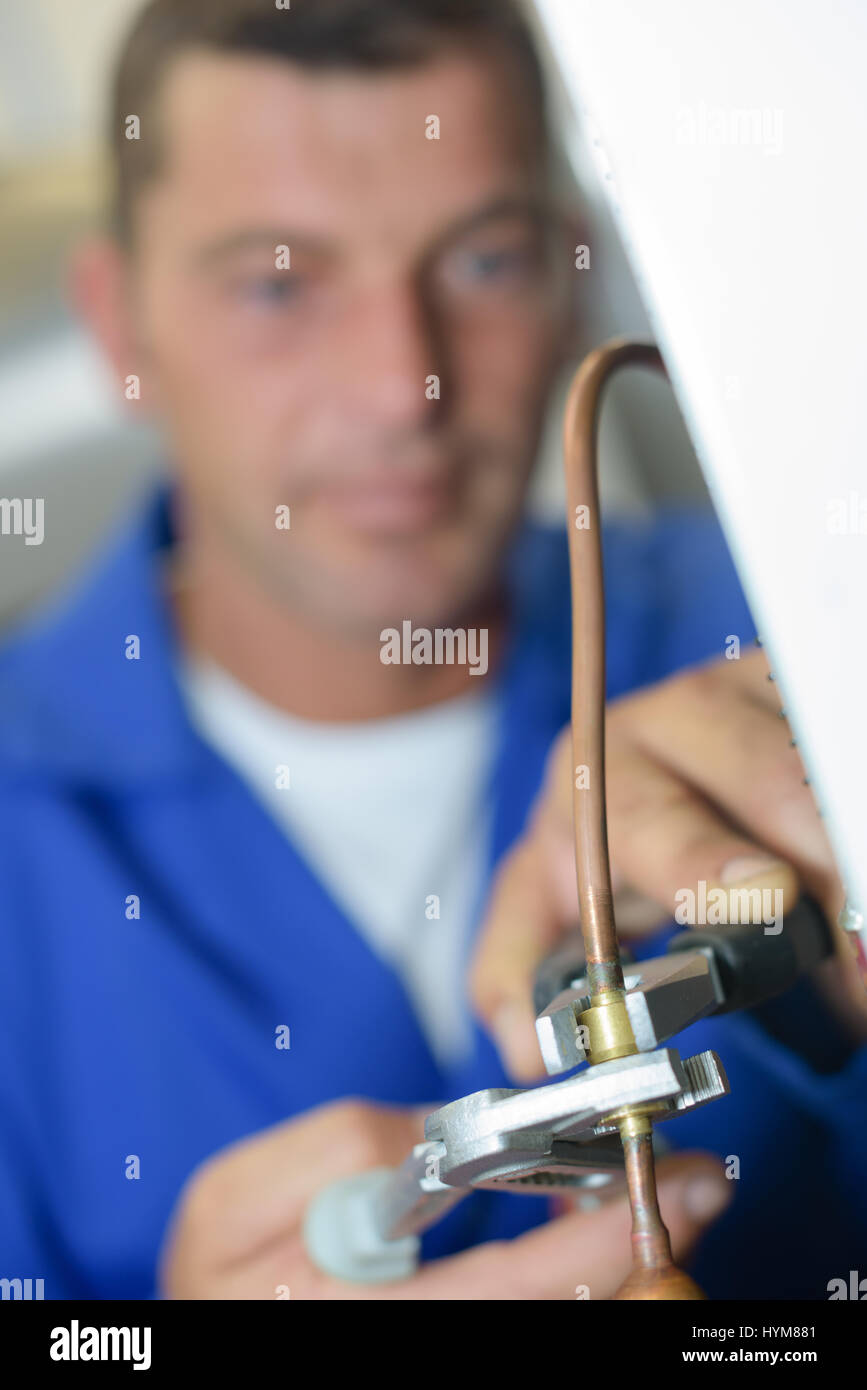 worker cutting wire Stock Photo - Alamy