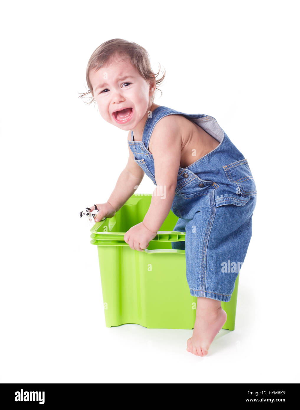 Kid plays with container Stock Photo - Alamy