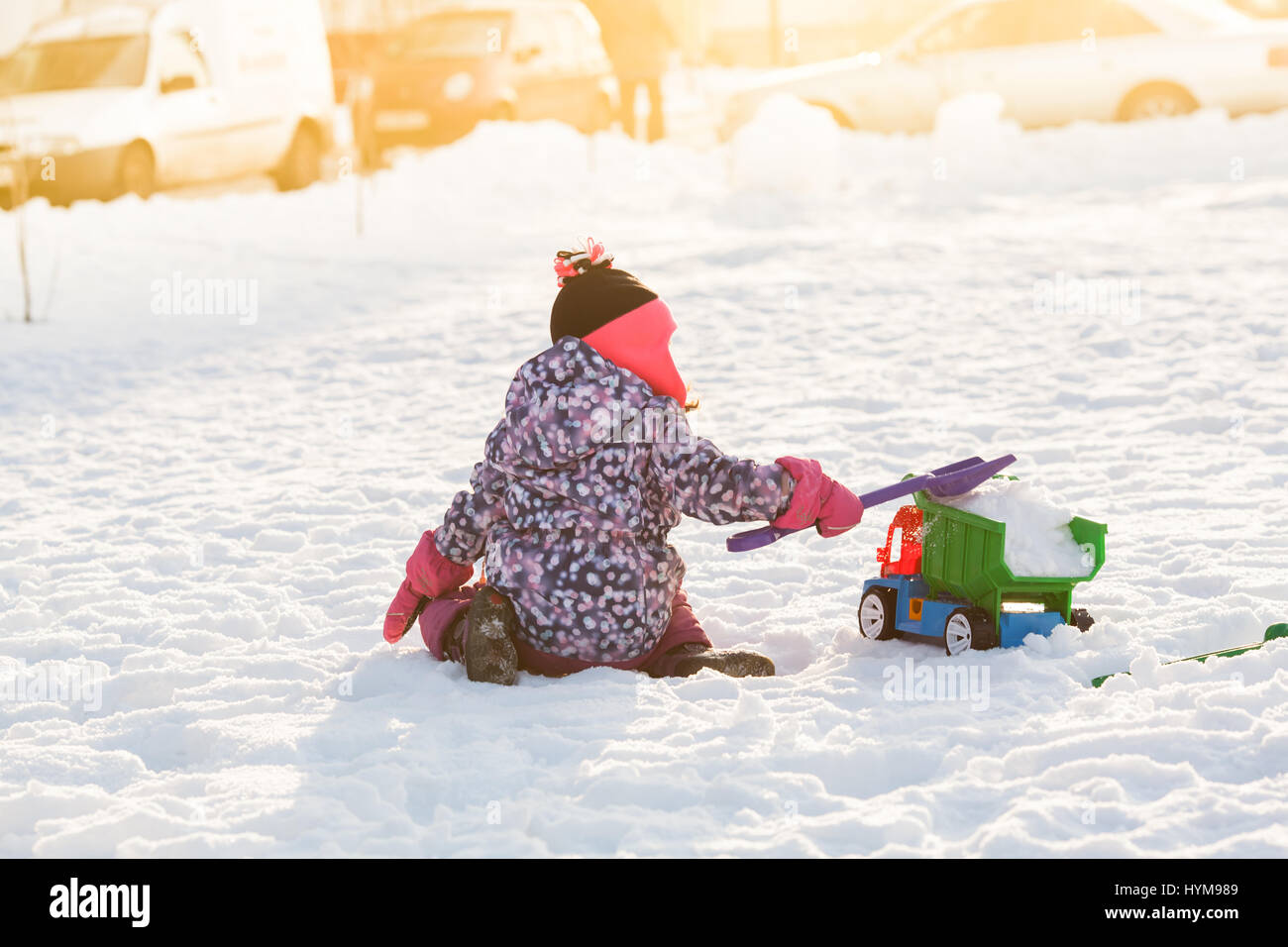 Kid play on the snow Stock Photo - Alamy